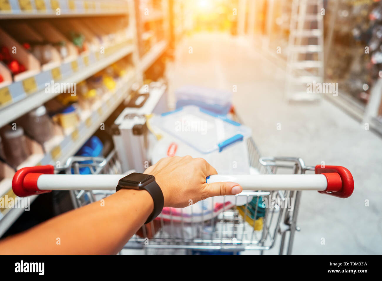 Human Hand Close Up With Shopping Cart in a Supermarket Walking Trough ...