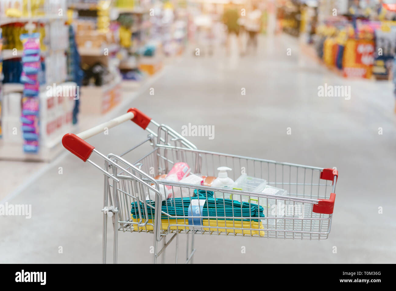 Trolley in a supermarket with various goods Stock Photo - Alamy