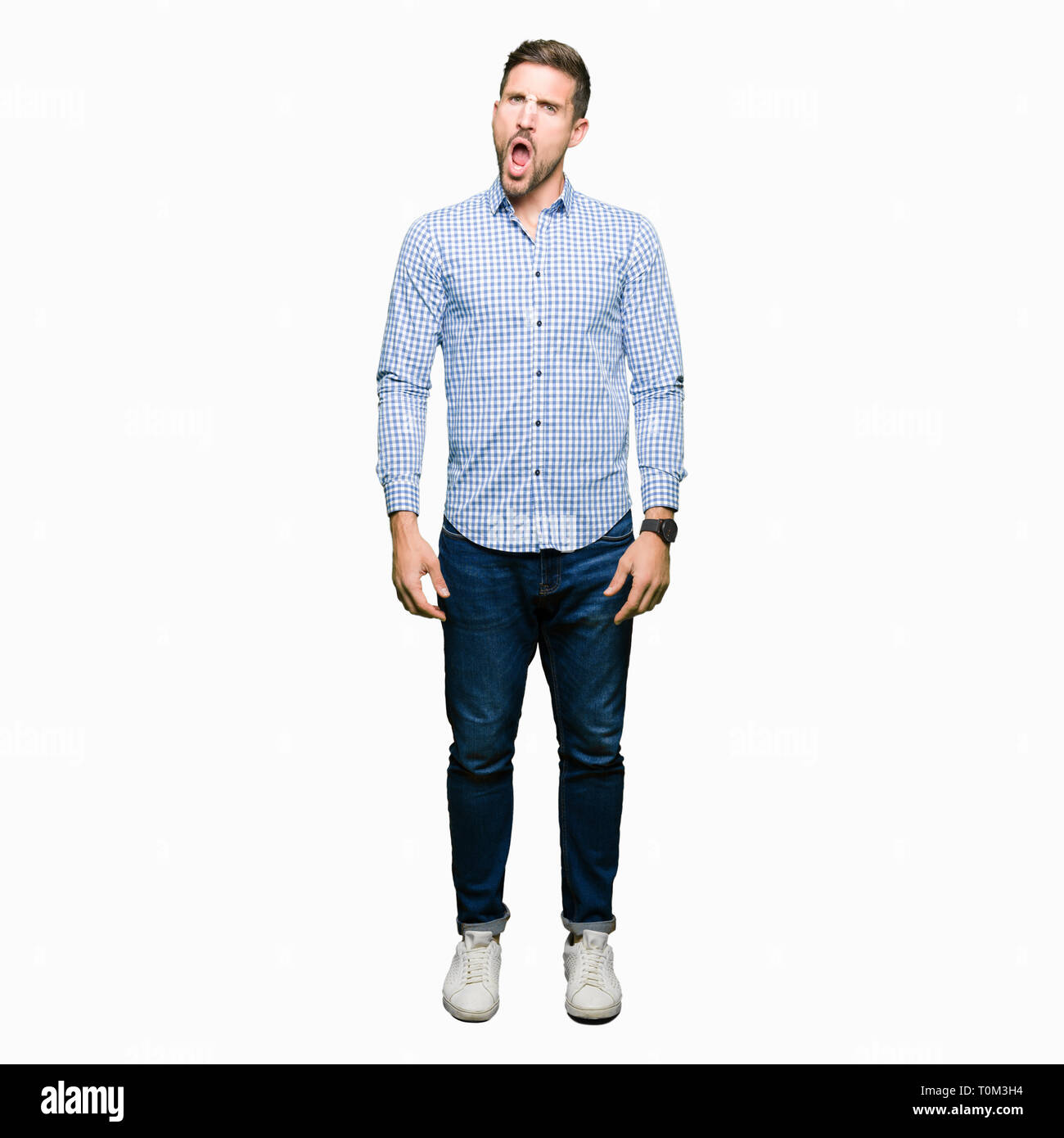 Handsome business man with blue eyes In shock face, looking skeptical ...