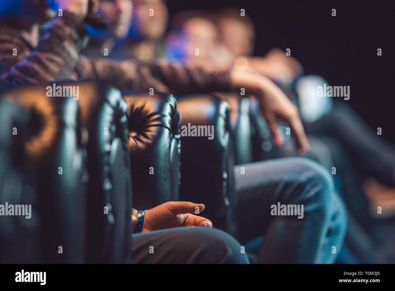 close-up of the clasped male hands sitting on a leather chair. the ...