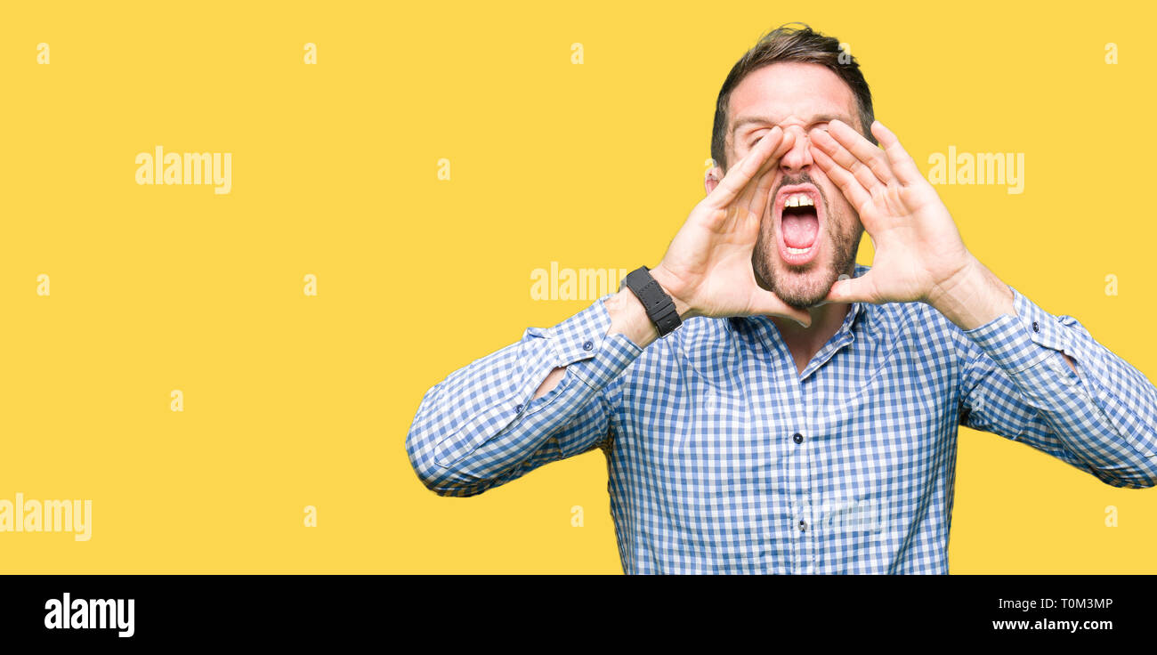 Handsome business man with blue eyes Shouting angry out loud with hands ...