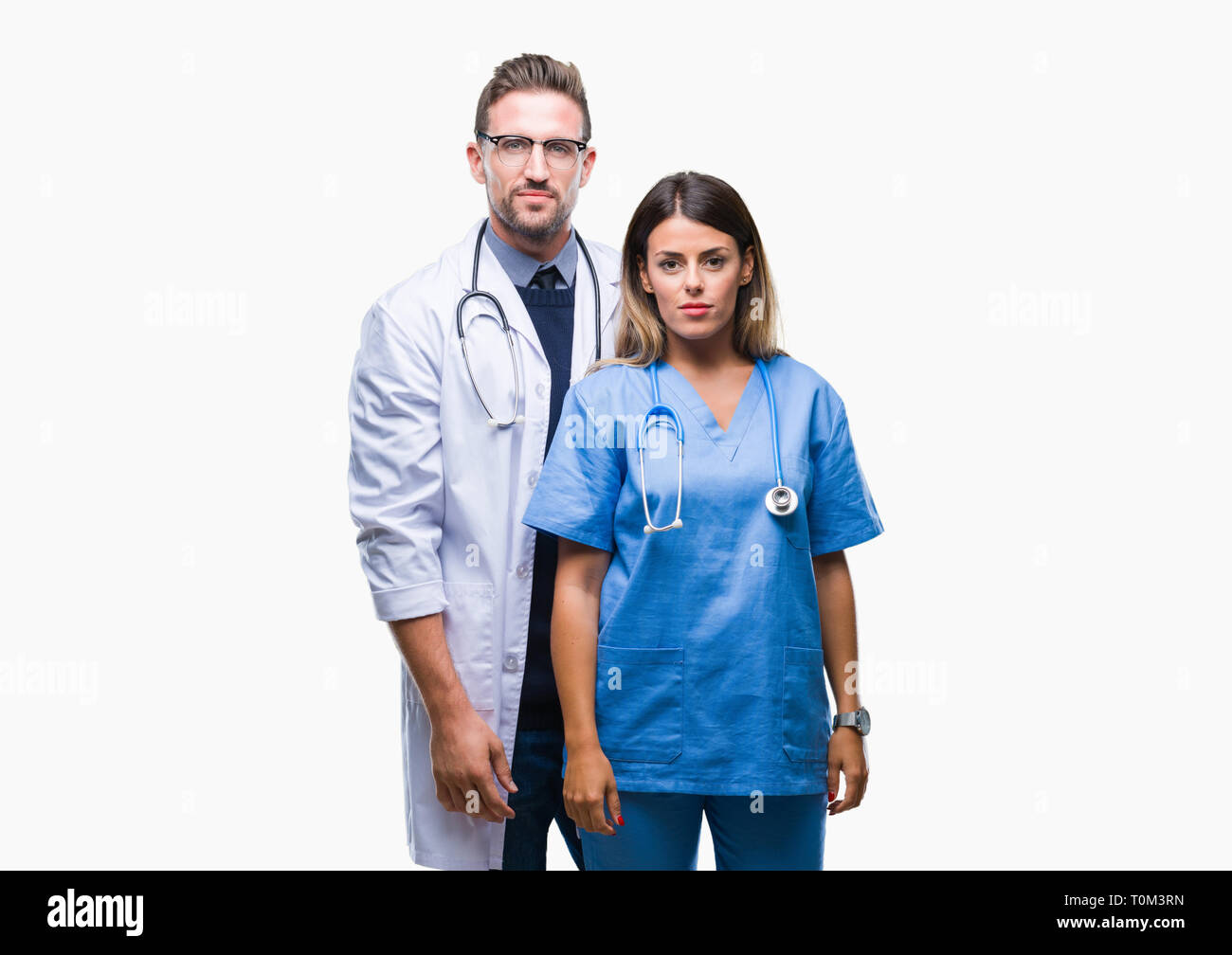 Young couple of doctor and surgeon over isolated background with ...