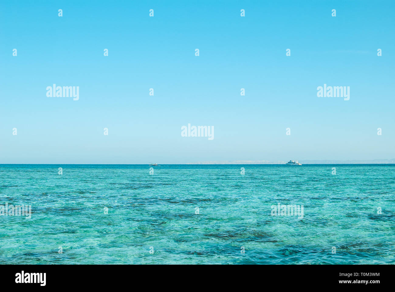 Wide shot of a beautiful clear turquoise sea ocean water surface with ...