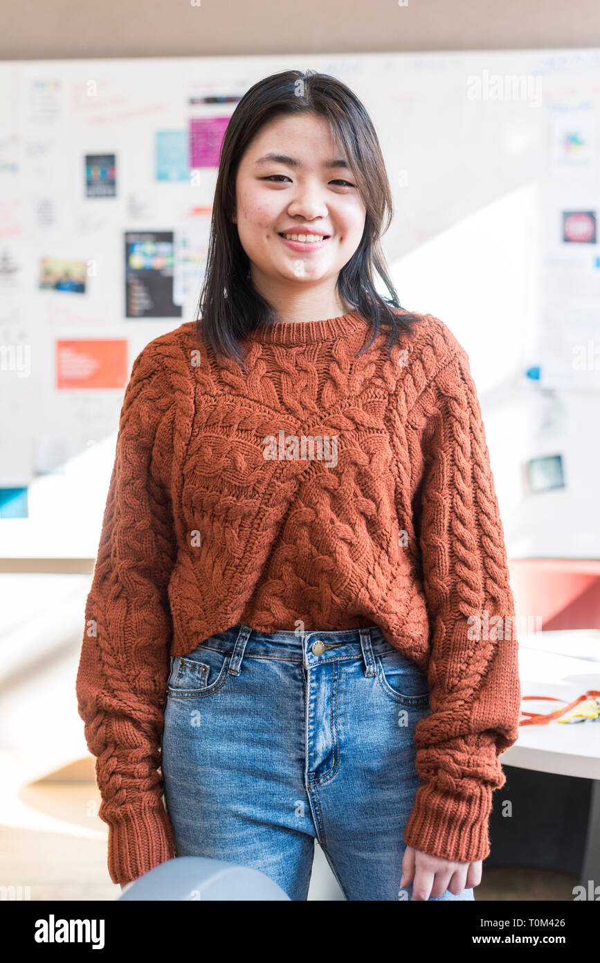 An Asian international student standing in the communal / common areas ...