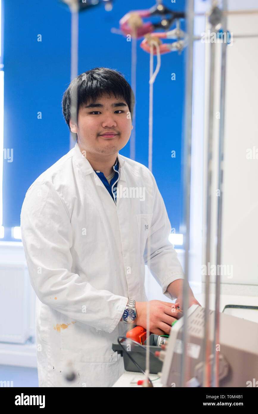 A young overseas international Asian college student in the science lab ...