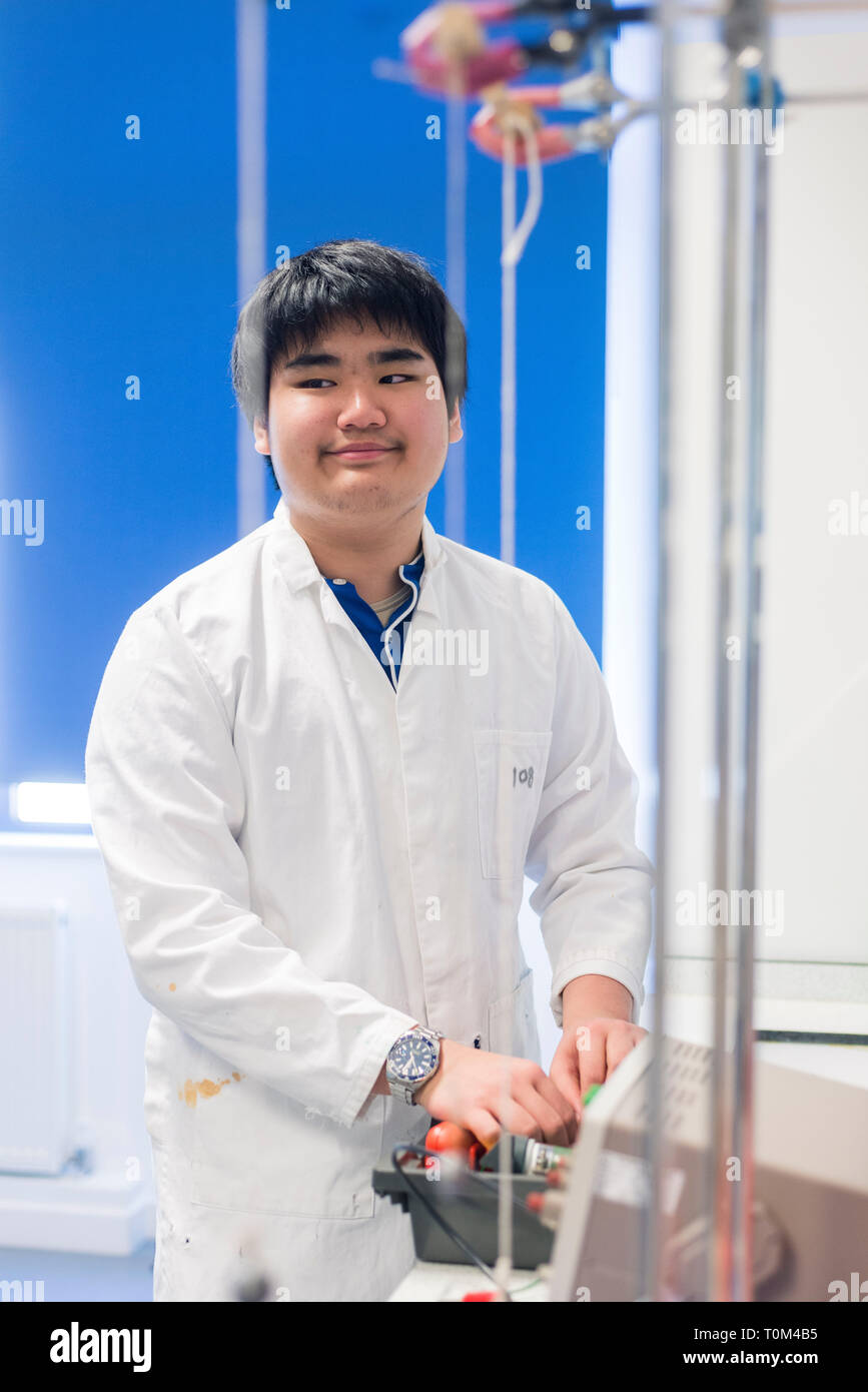 A young overseas international Asian college student in the science lab ...