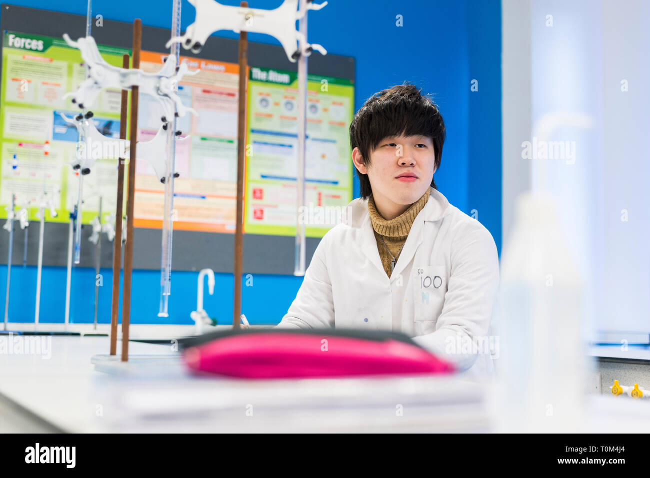 A young overseas international Asian college student in the science lab ...