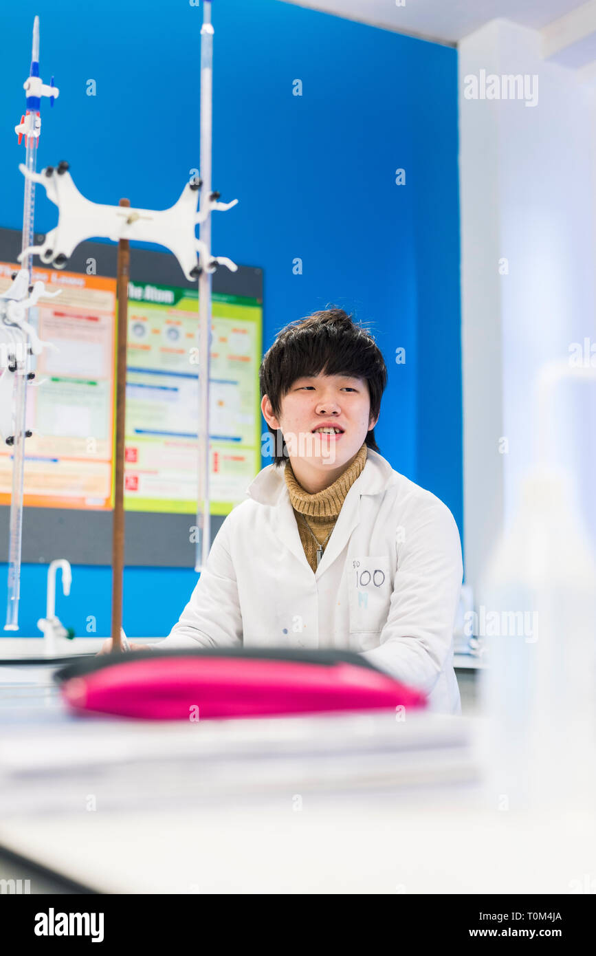 A young overseas international Asian college student in the science lab ...