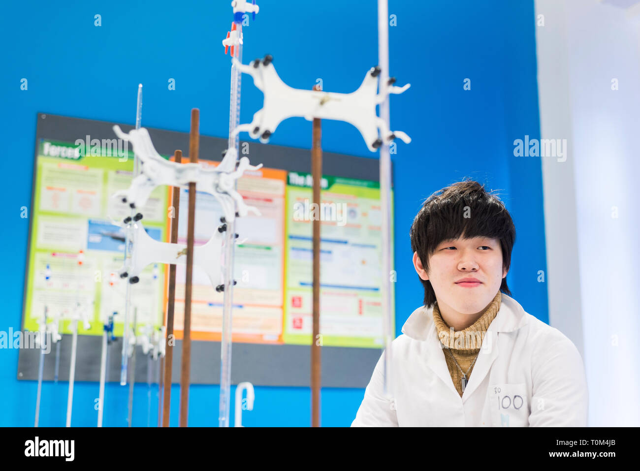 A young overseas international Asian college student in the science lab ...