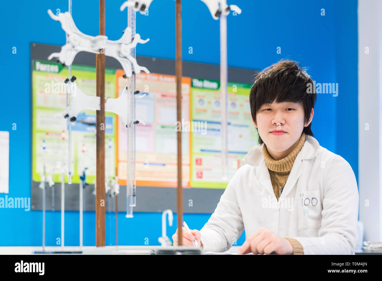 A young overseas international Asian college student in the science lab ...