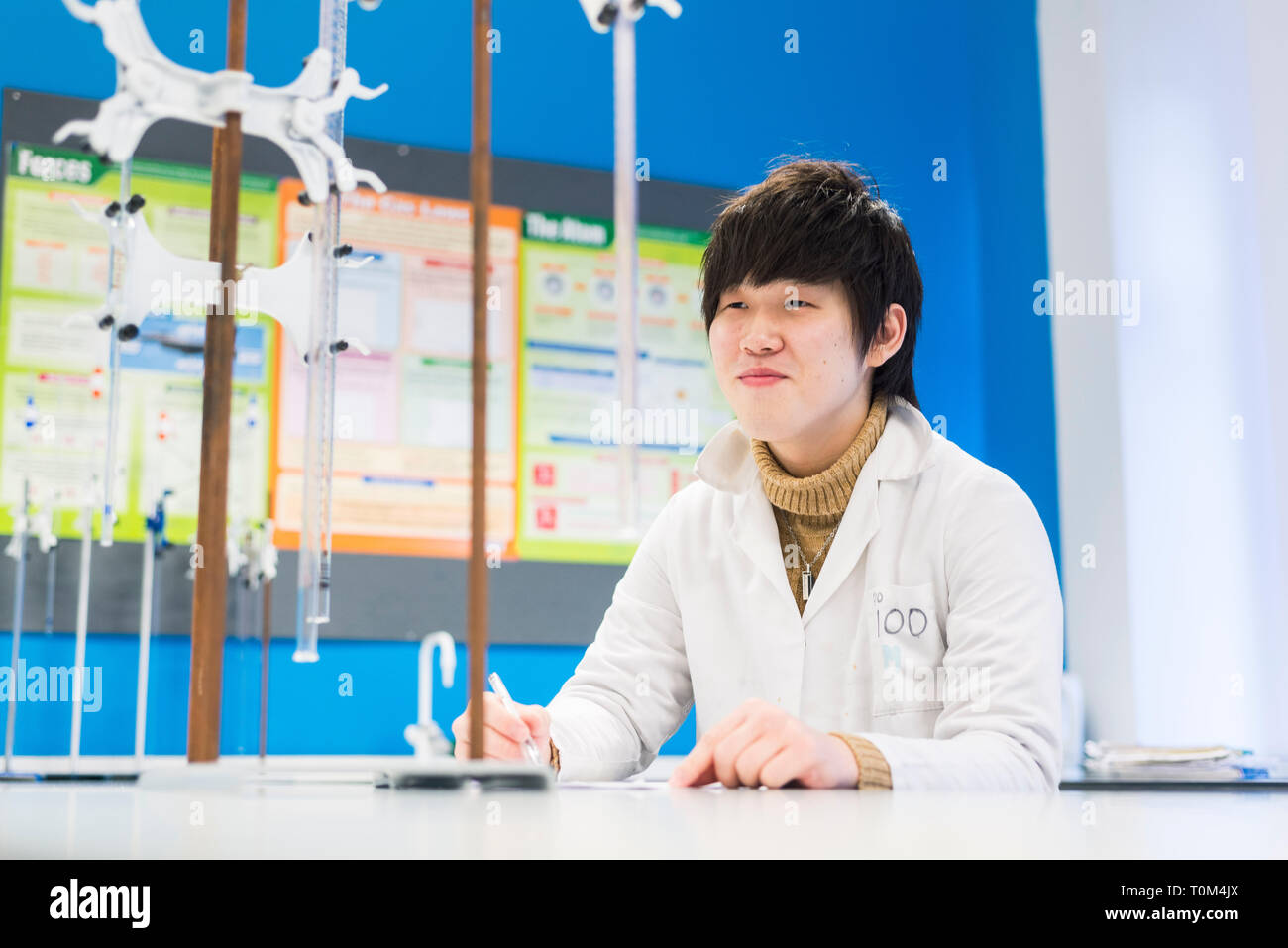 A young overseas international Asian college student in the science lab ...