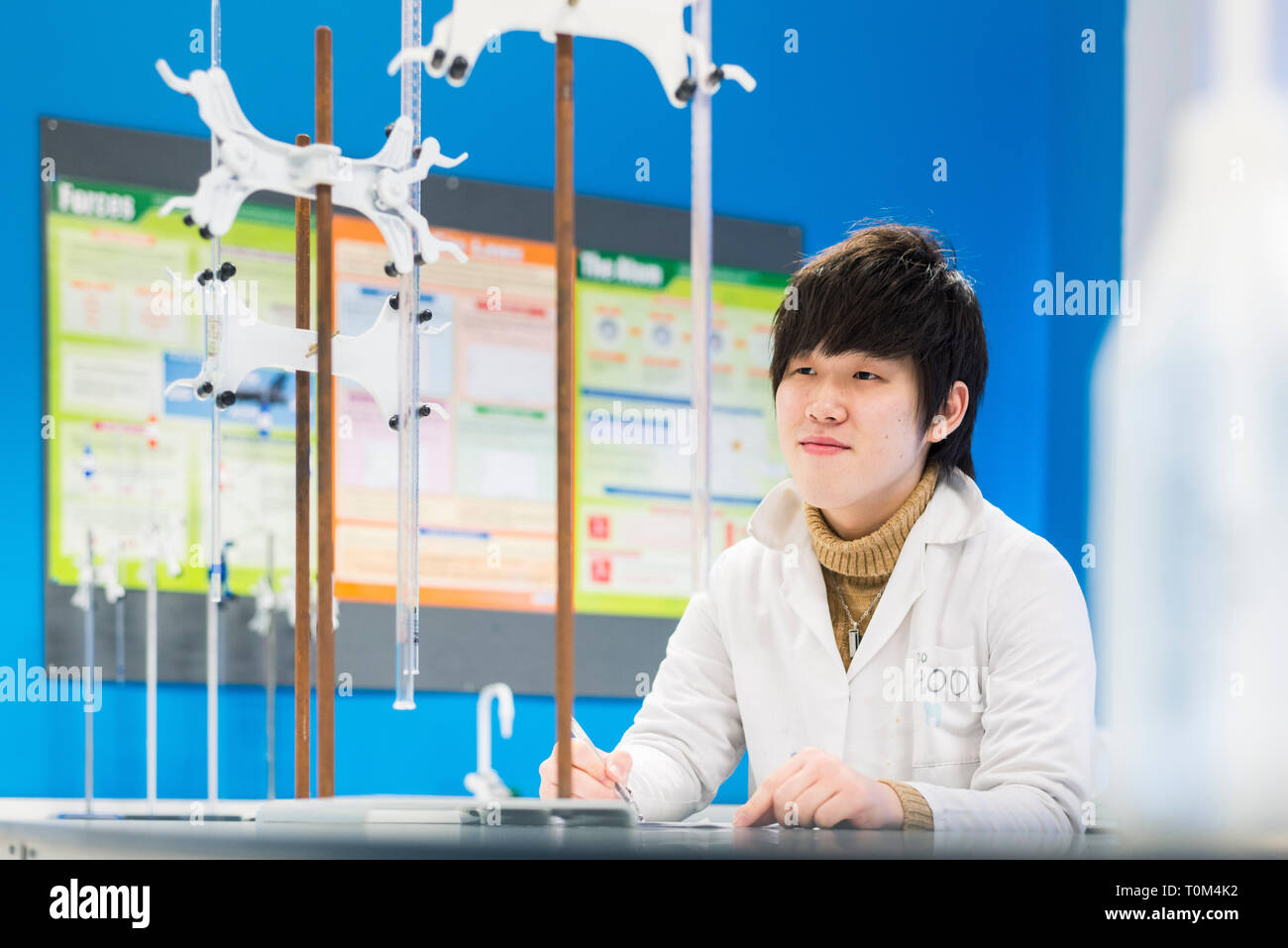 A young overseas international Asian college student in the science lab ...