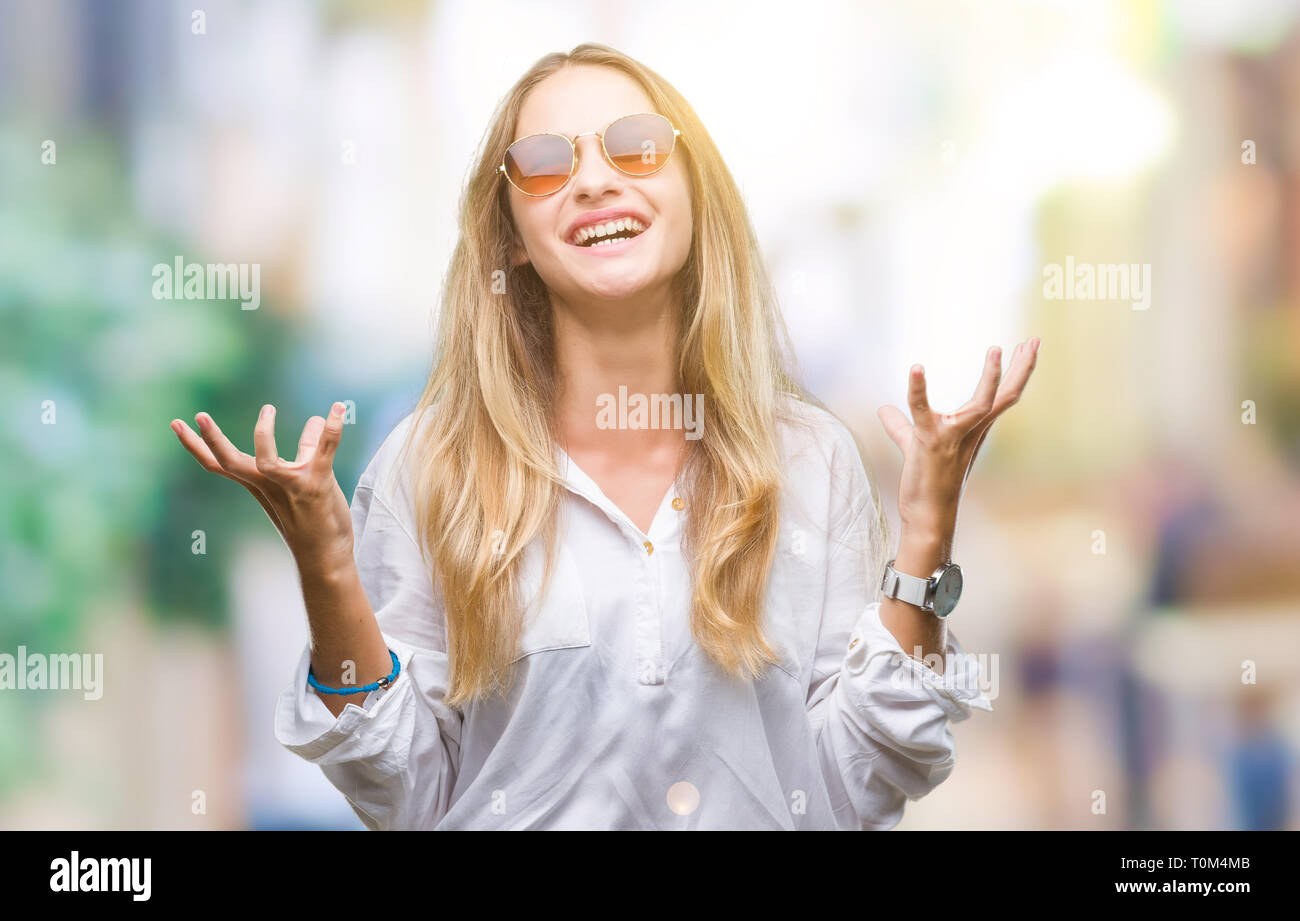 Young beautiful blonde woman wearing sunglasses over isolated ...