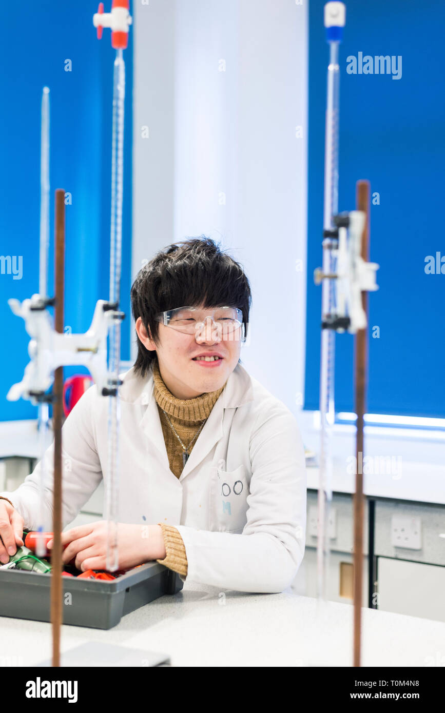 A young overseas international Asian college student in the science lab ...