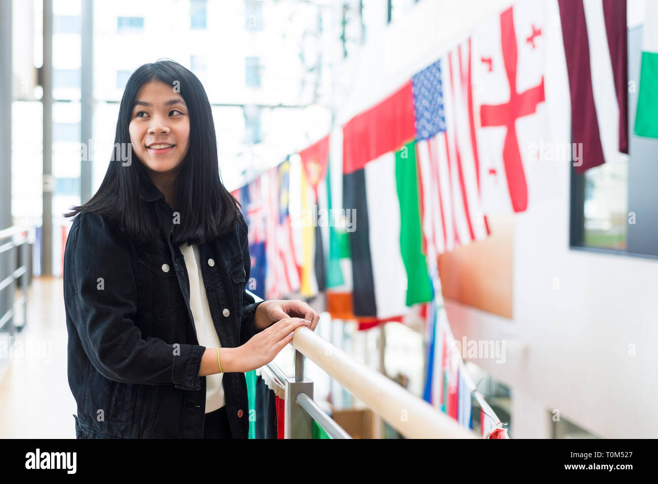 An Asian international student standing in the communal / common areas ...
