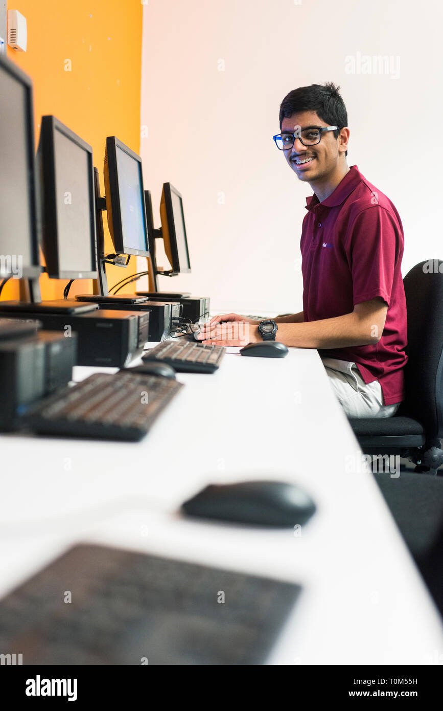 A young international student from the indian subcontinent works in the ...