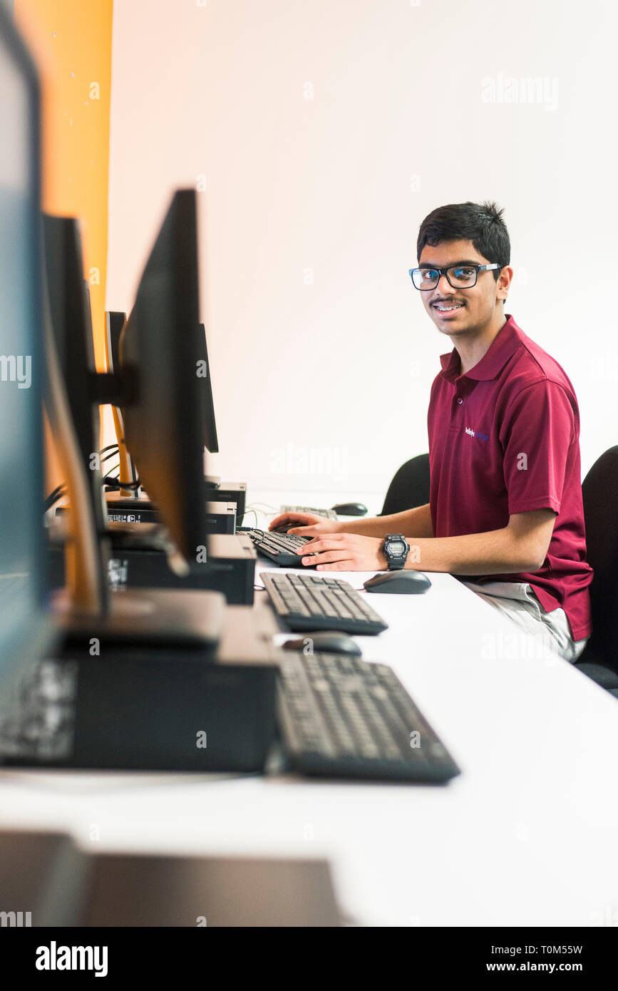 A young international student from the indian subcontinent works in the ...