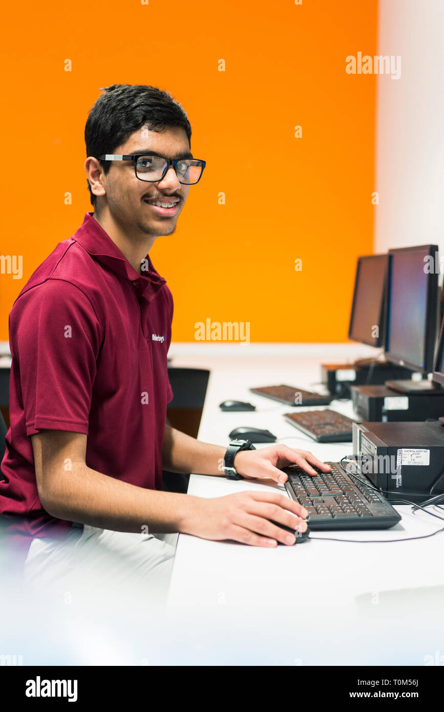 A young international student from the indian subcontinent works in the ...