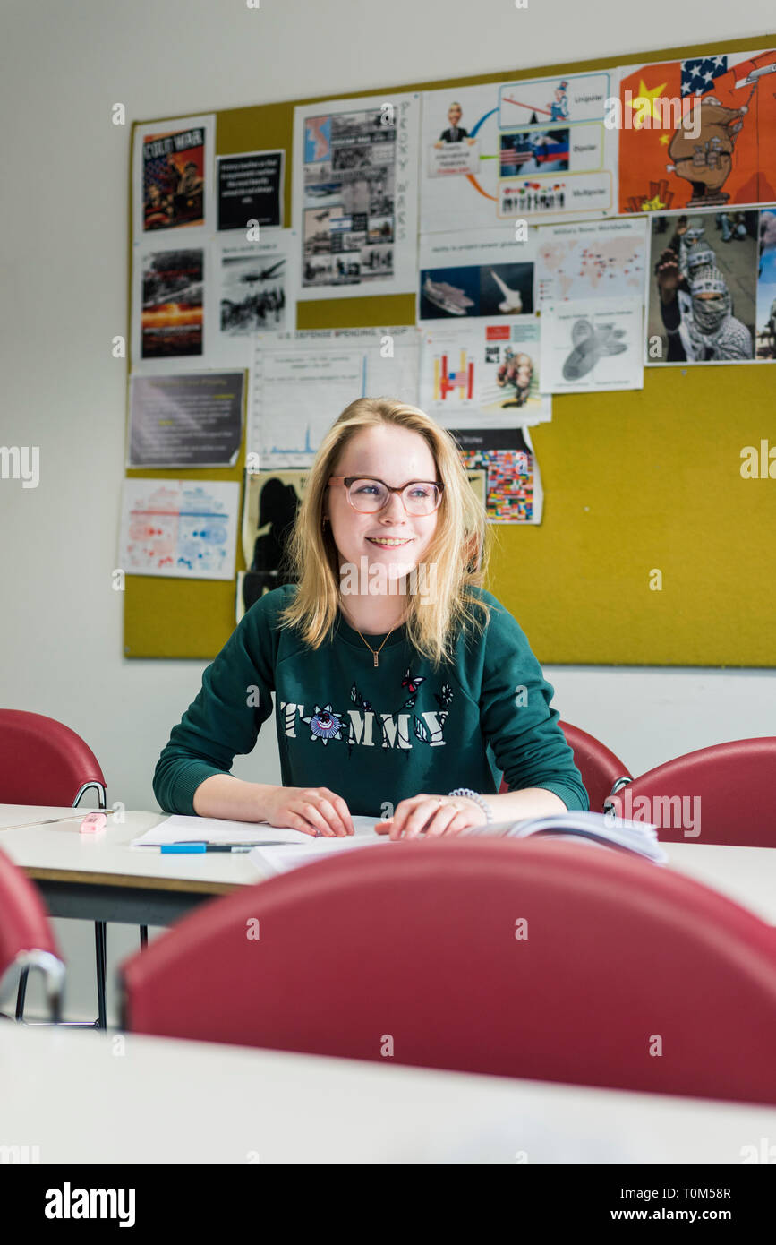 A young european student works in a classroom on campus of a Brighton ...