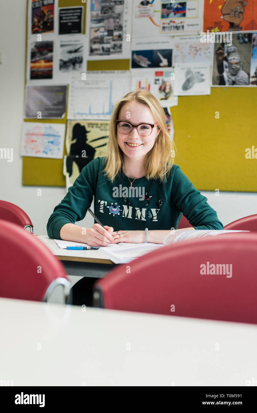 A young european student works in a classroom on campus of a Brighton ...