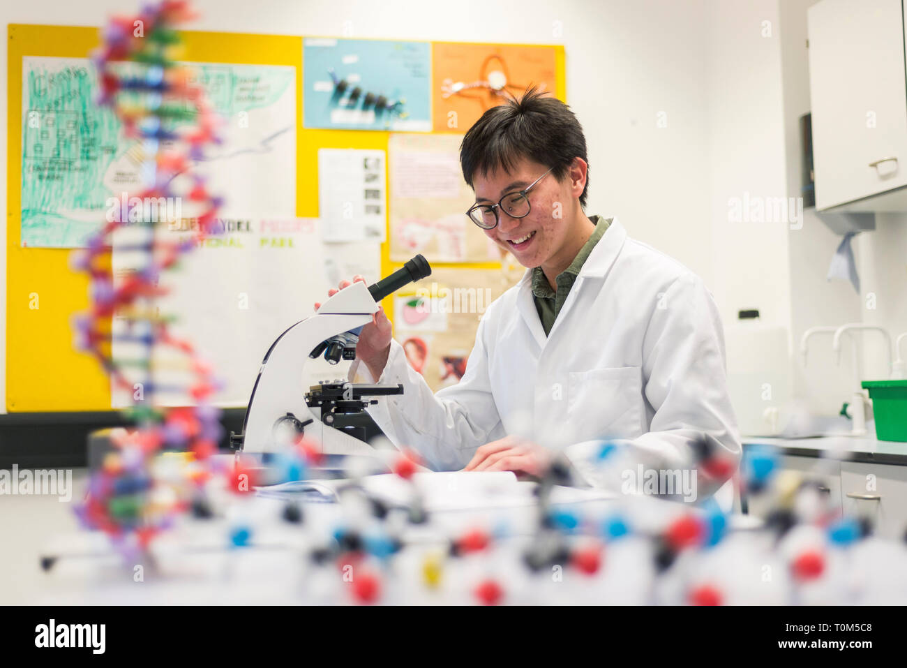 A young overseas international Asian college student in the science lab ...
