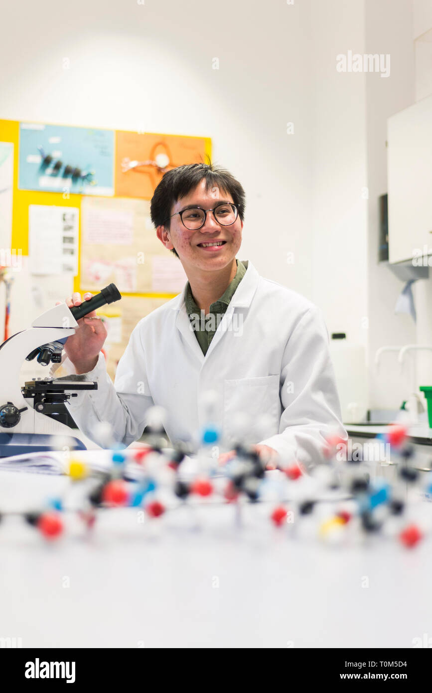 A young overseas international Asian college student in the science lab ...