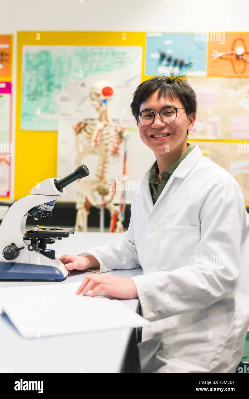 A young overseas international Asian college student in the science lab ...