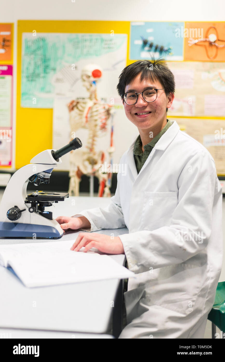 A young overseas international Asian college student in the science lab ...