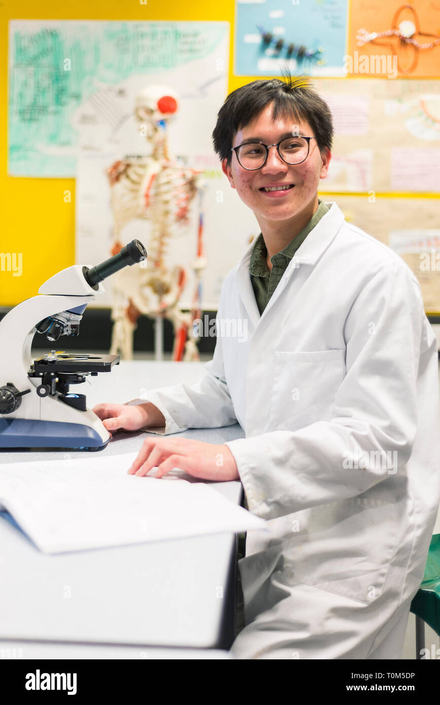 A young overseas international Asian college student in the science lab ...