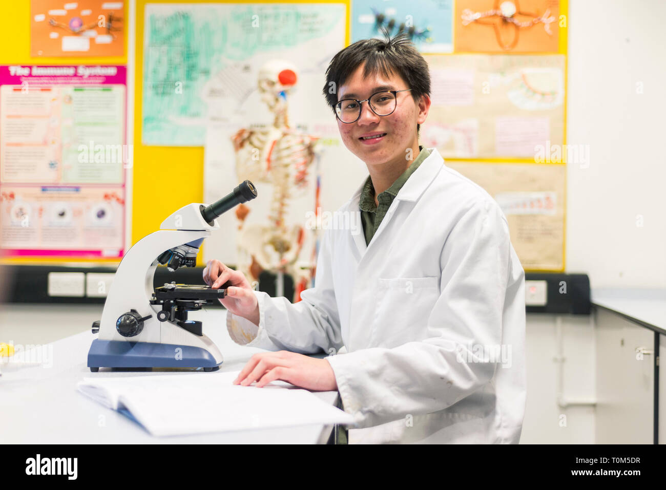 A young overseas international Asian college student in the science lab ...