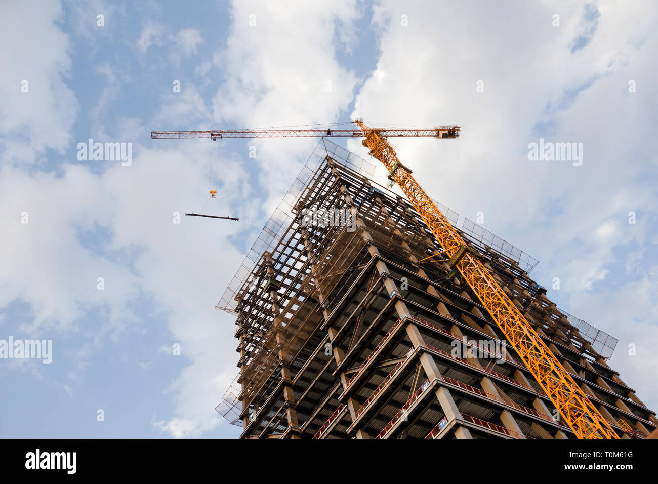 Tall building under construction with scaffolding and tower crane Stock ...