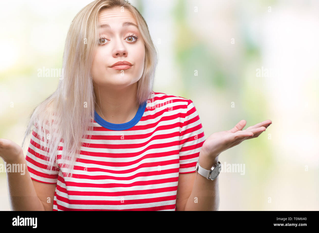 Young blonde woman over isolated background clueless and confused ...
