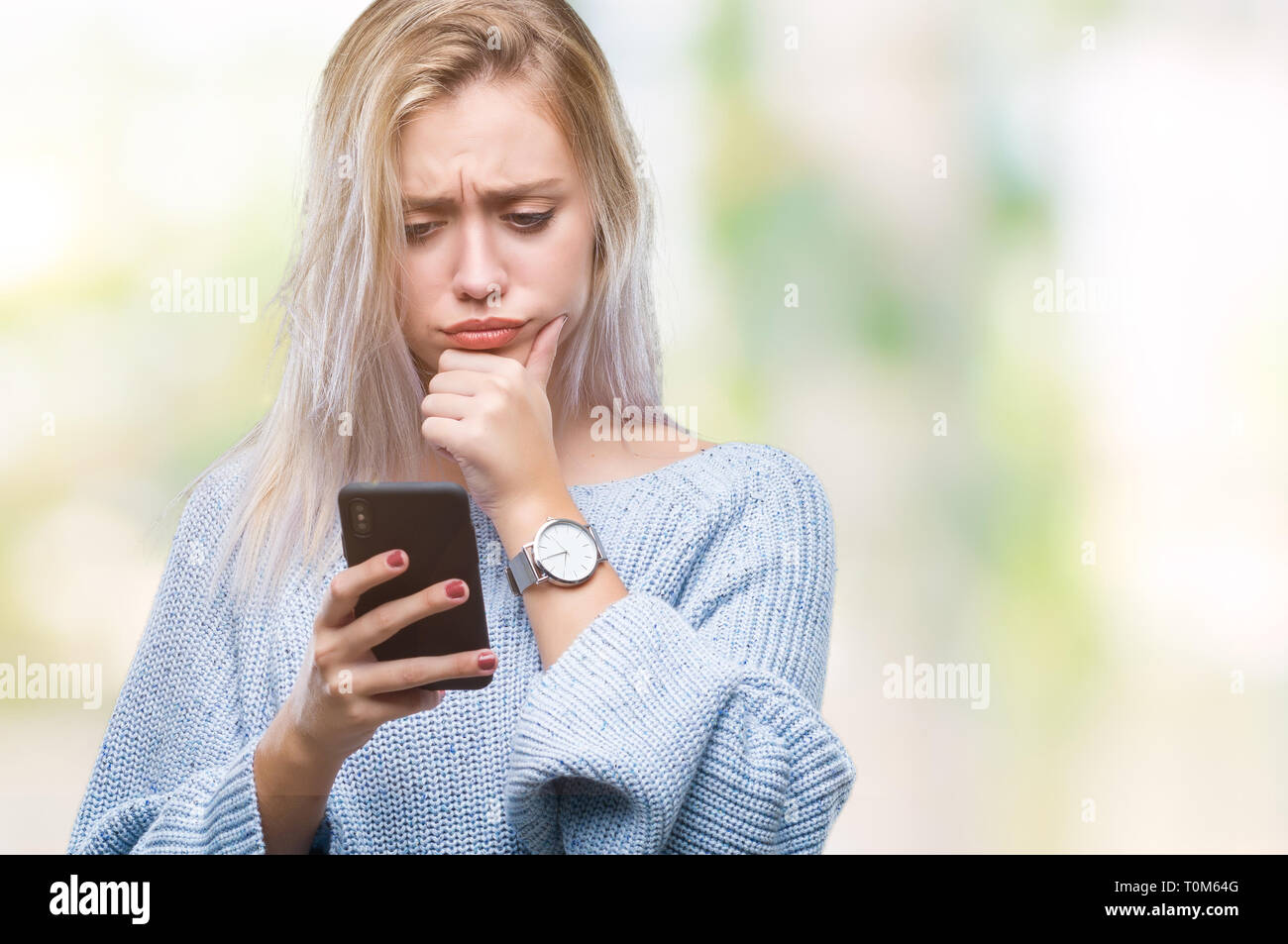 Young blonde woman texting sending message using smartphone over ...