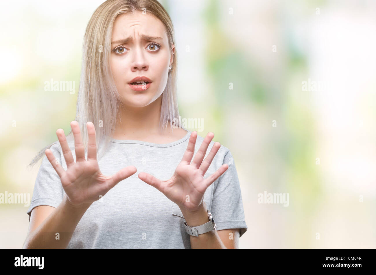 Young blonde woman over isolated background afraid and terrified with ...