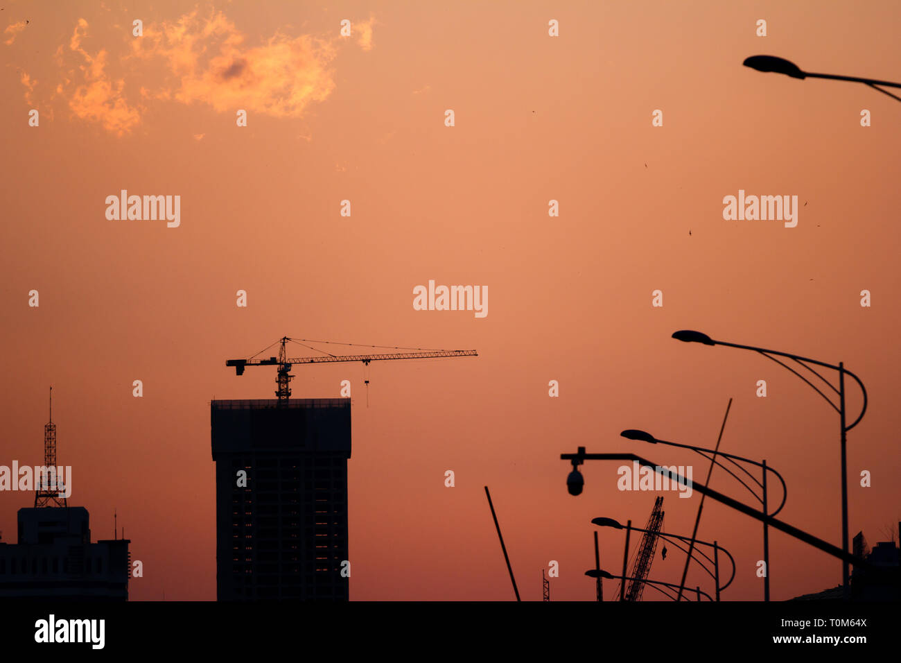 Building under construction with red sky background Stock Photo - Alamy