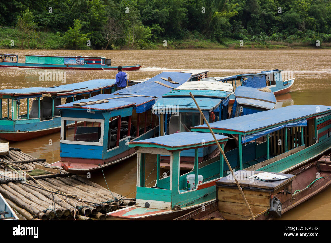 Wooden longboats on Mekong river in Laos Stock Photo - Alamy
