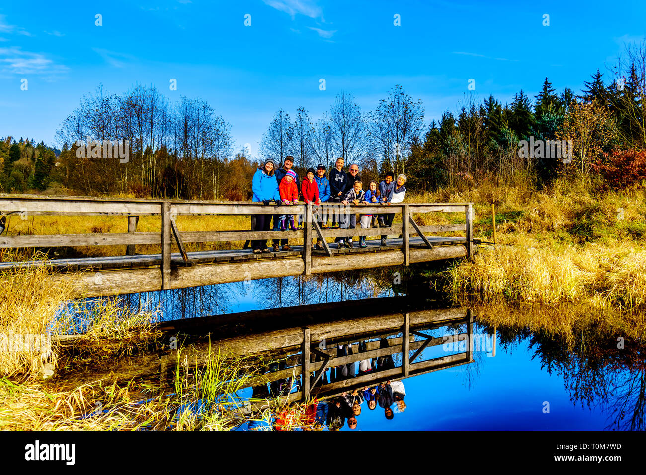 Three generations of a family on a bridge on the hiking trails of ...