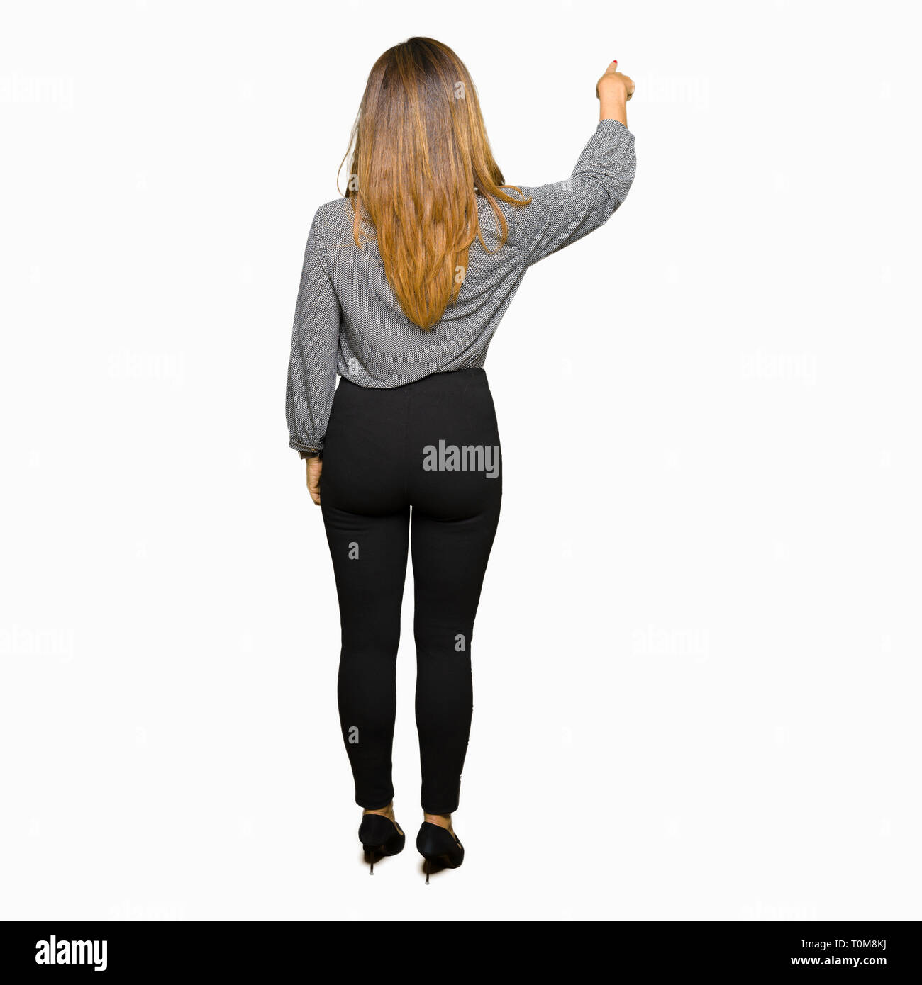 Beautiful middle age business woman Posing backwards pointing behind ...