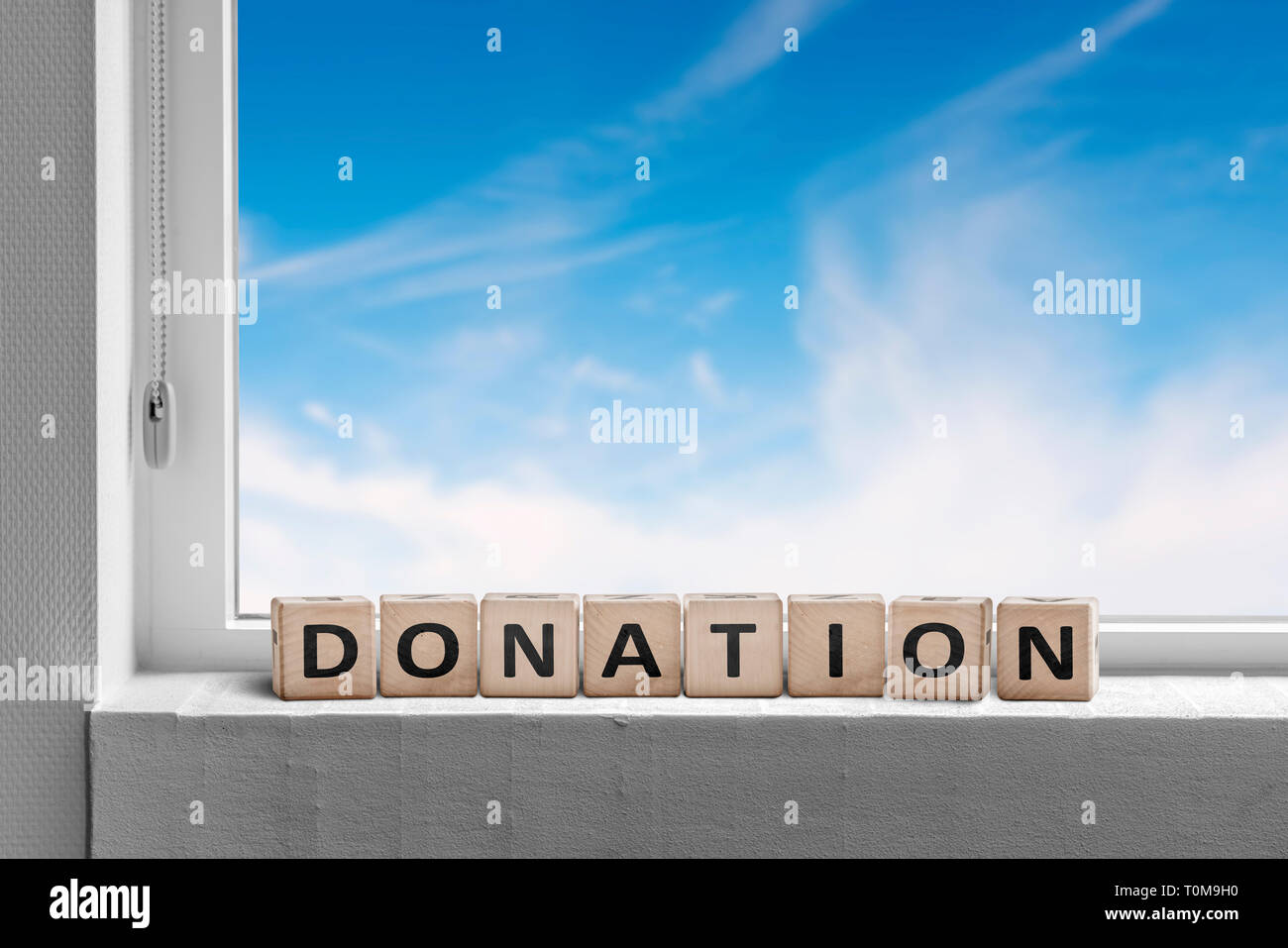 Donation sign standing in a window with a blue heaven outside Stock ...