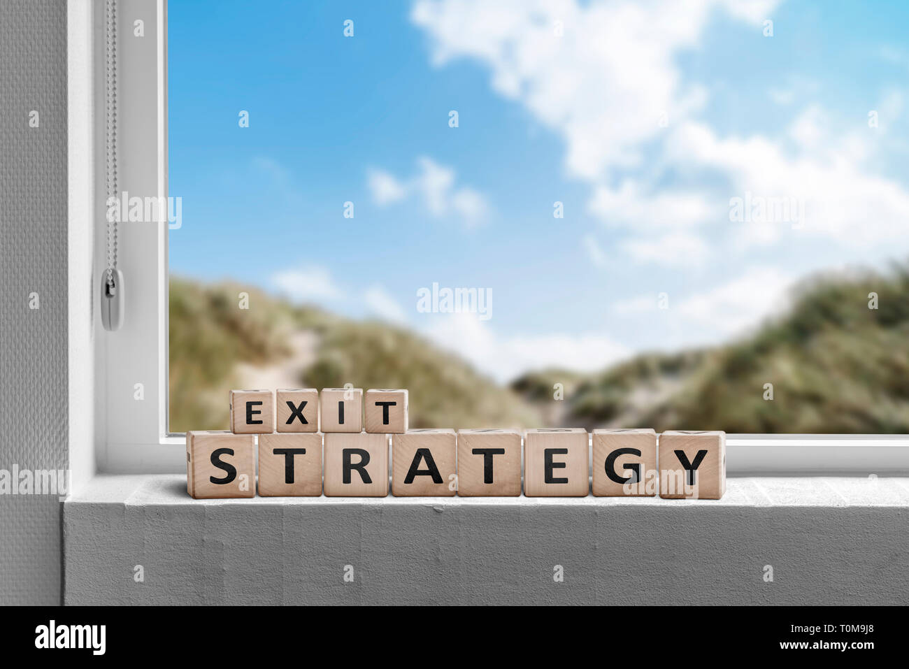 Exit strategy sign in a window with a view to beautiful nature under a ...