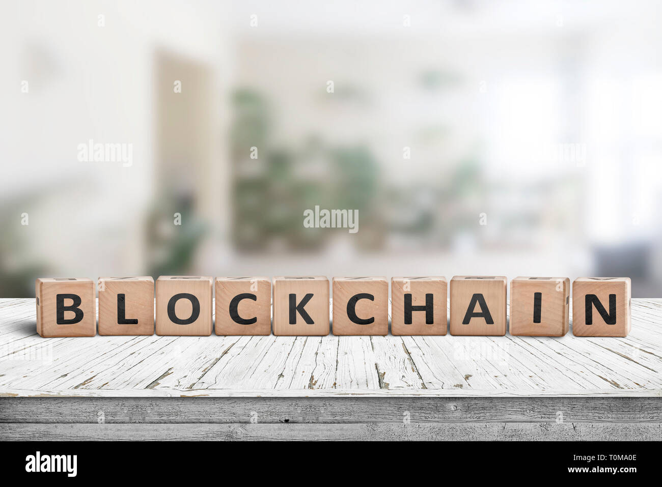 Blockchain sign made of wood on a desk in a bright living room Stock ...