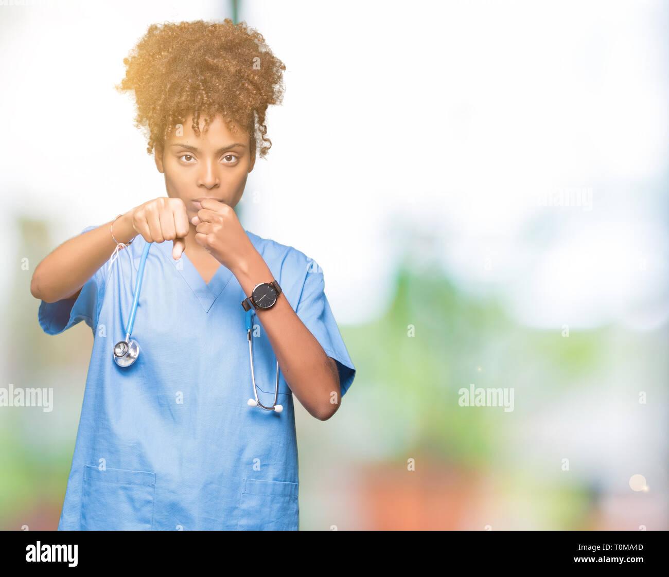 Young african american doctor woman over isolated background Punching ...