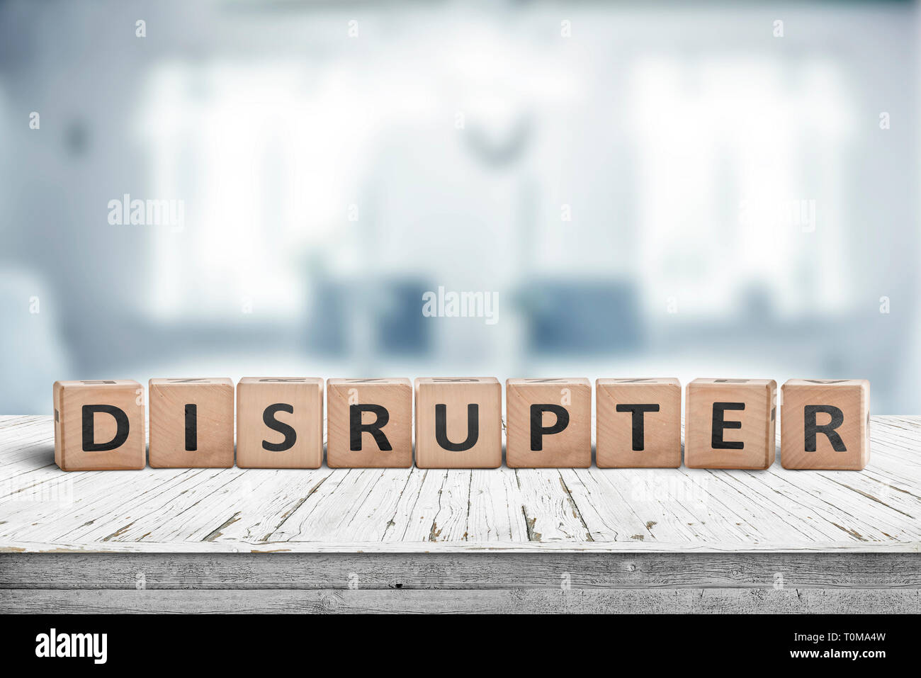 Disrupter sign on an office desk on a bright blue room in daylight ...