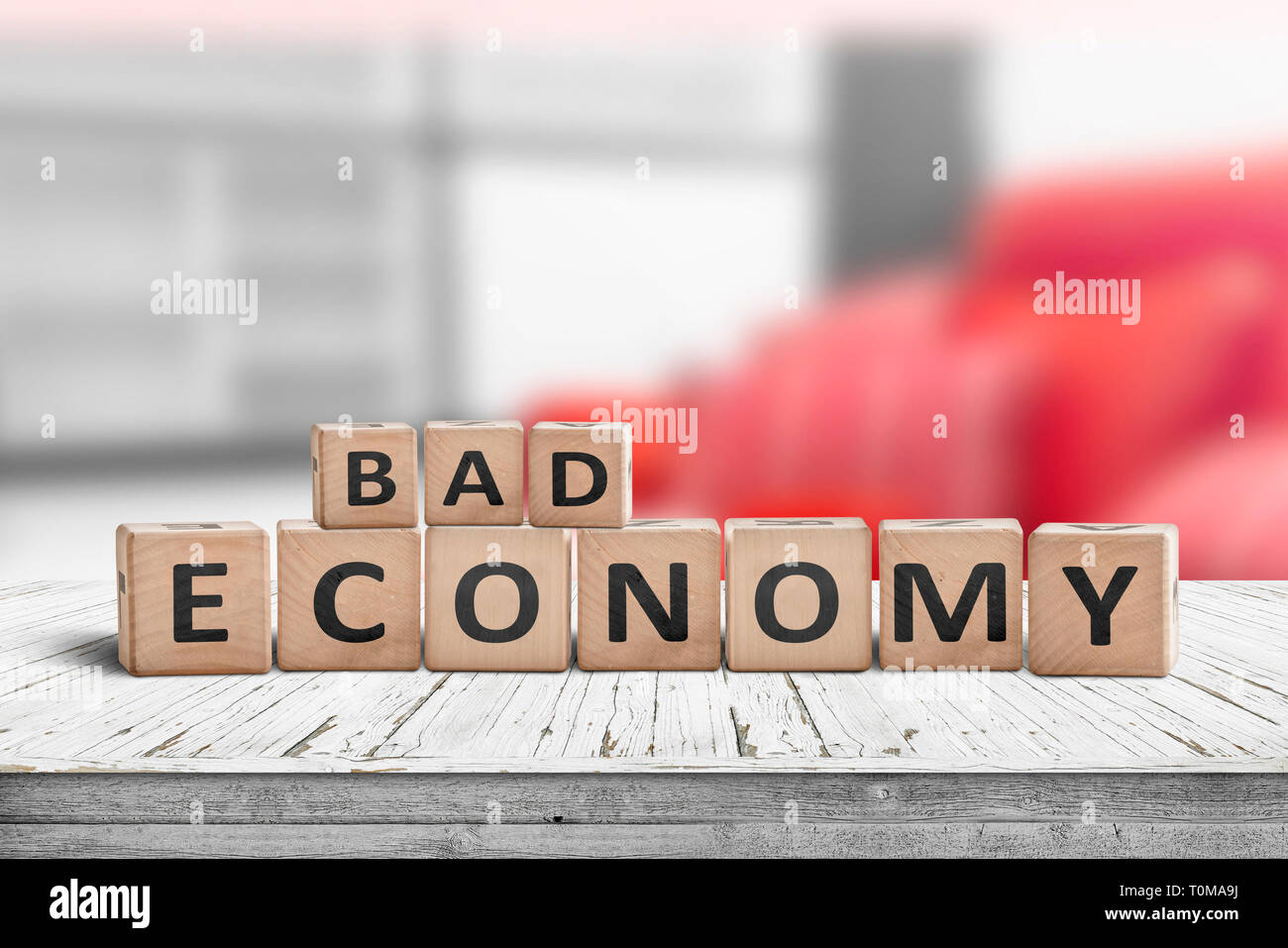 Bad economy sign on a wooden desk in an office with red color in the ...