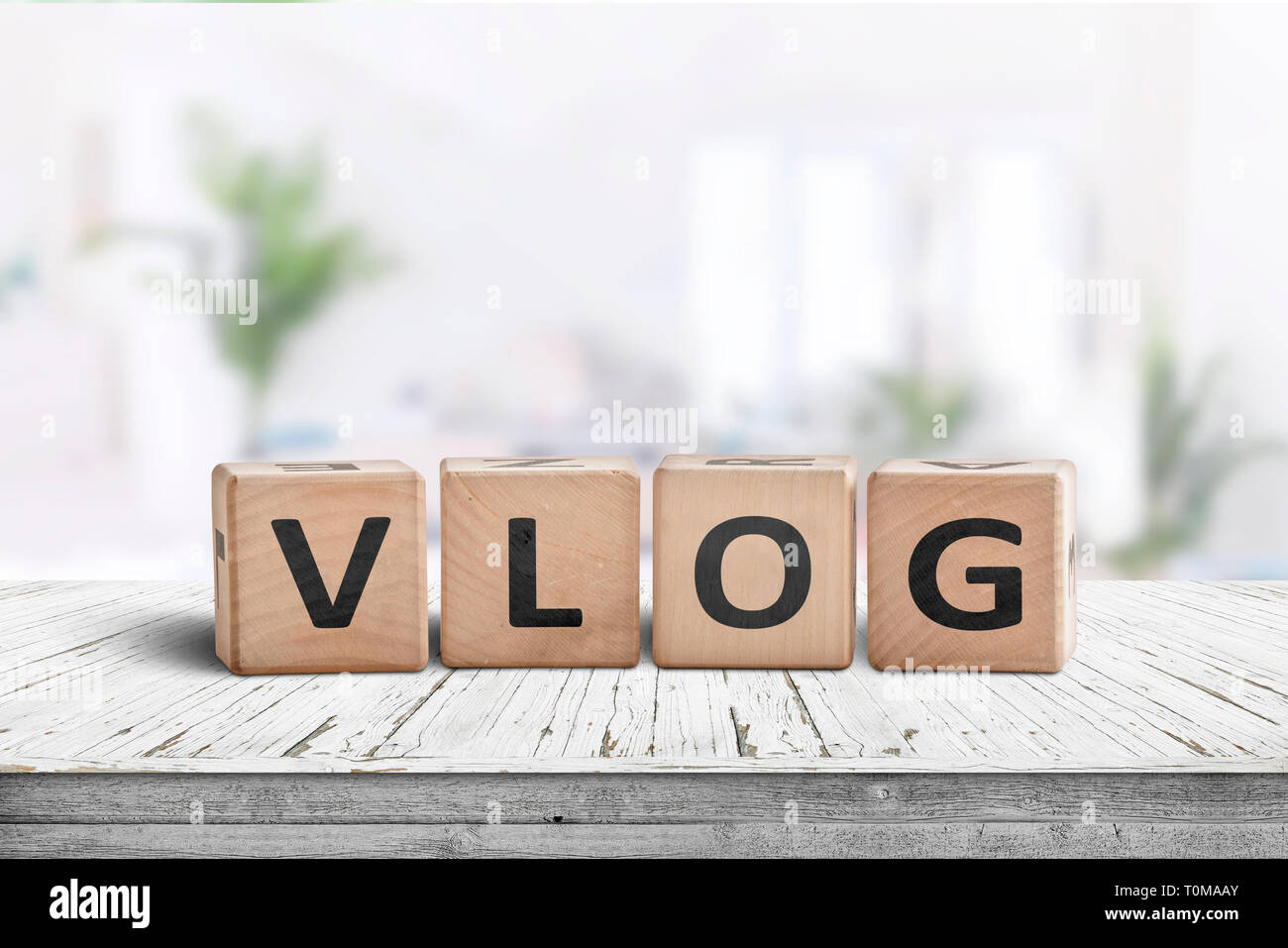 Vlog sign on a desk in a bright living room in the middle of the day ...