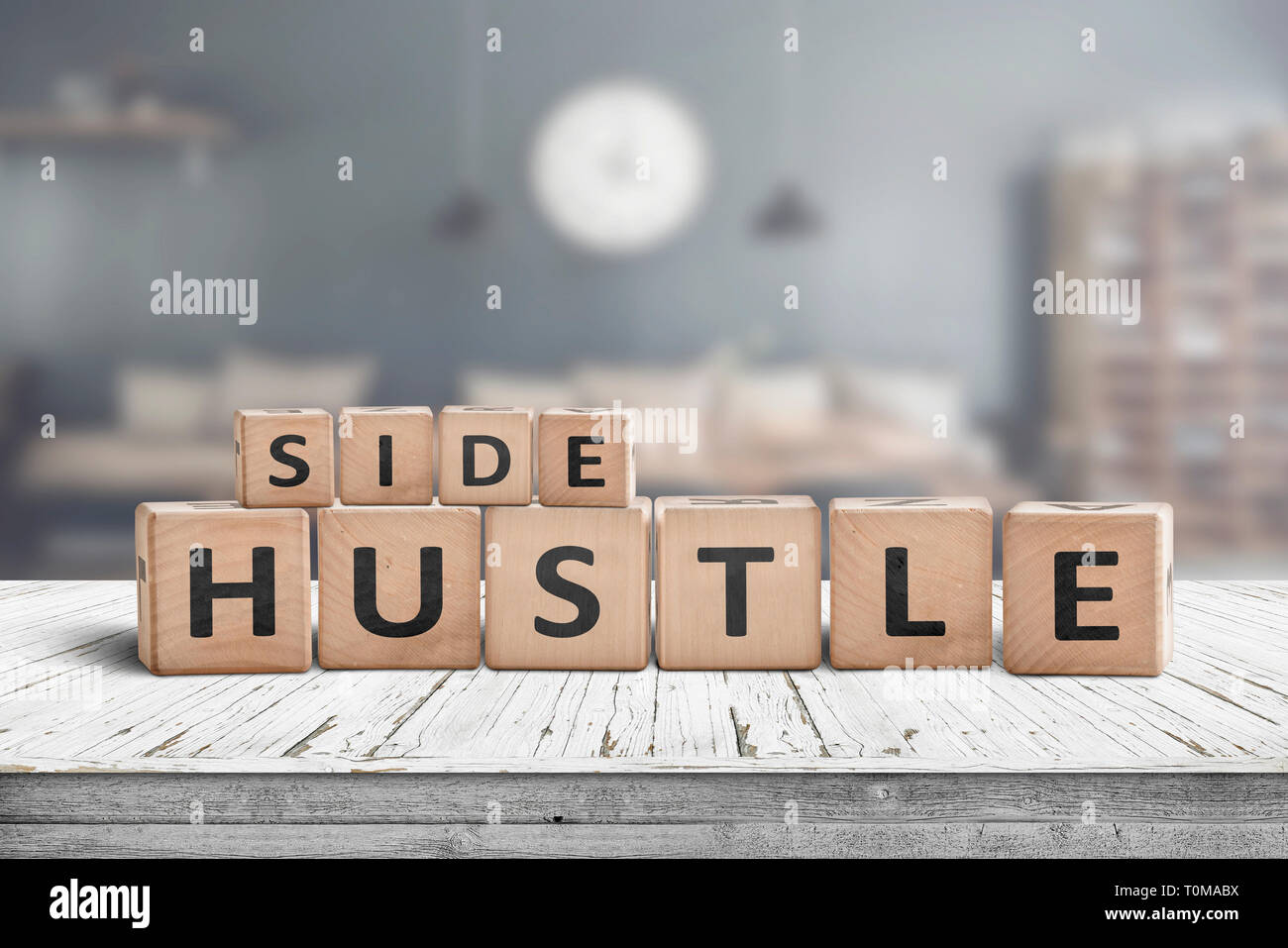 Side hustle sign on a plank table in a decorative room with a clock ...