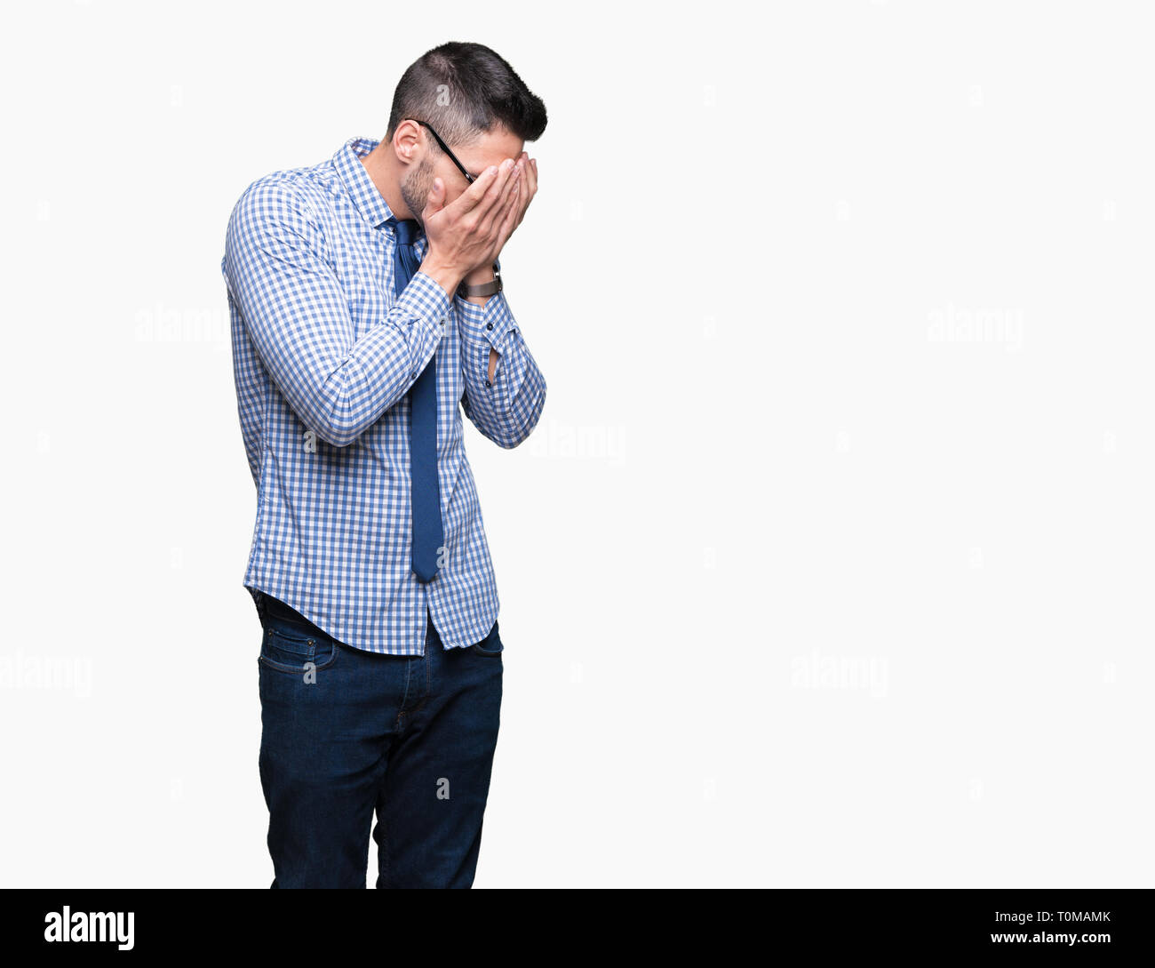 Young business man wearing glasses over isolated background with sad ...
