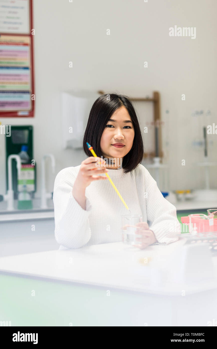 a young asian female student working in the science lab of a cambridge ...