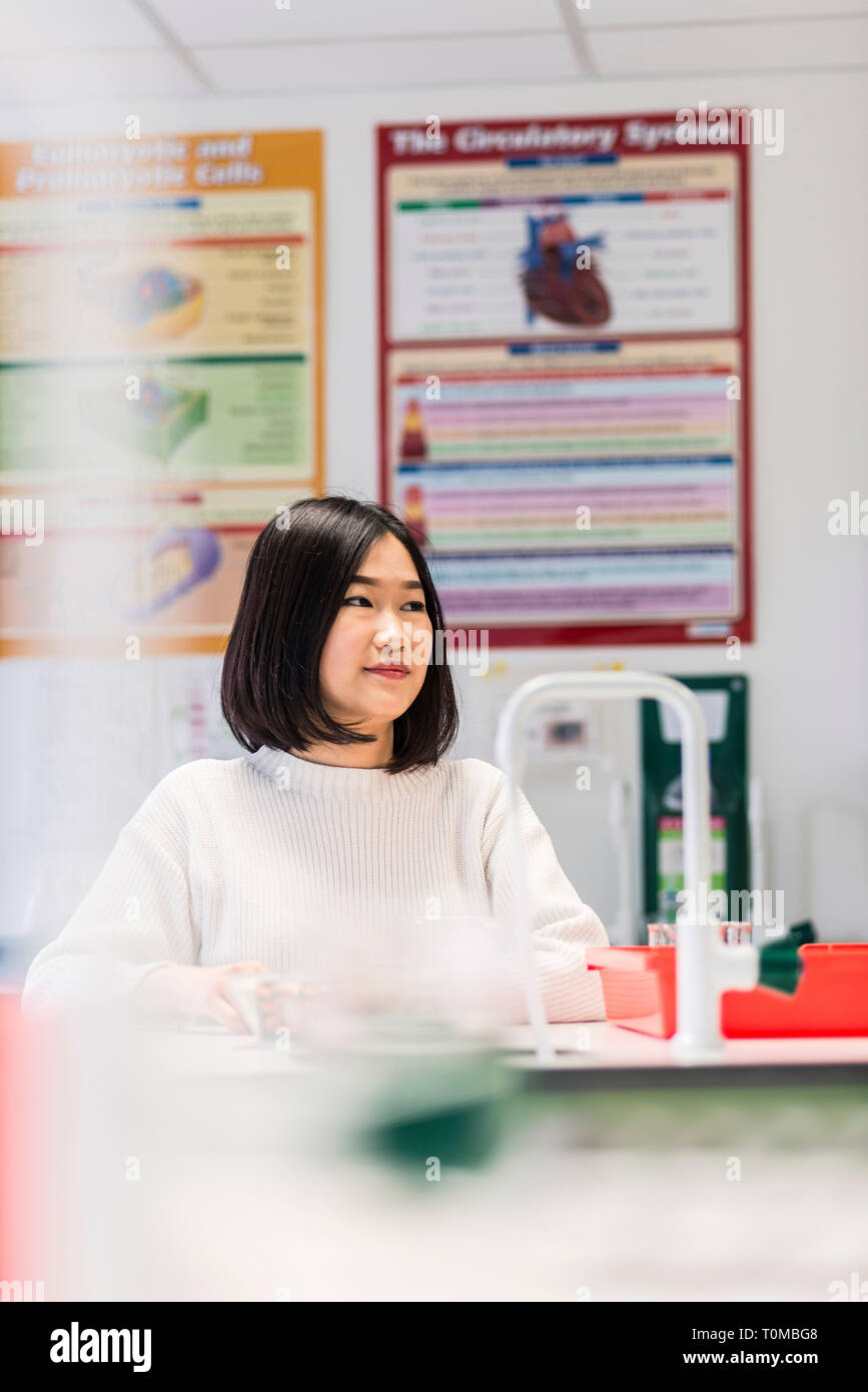 a young asian female student working in the science lab of a cambridge ...