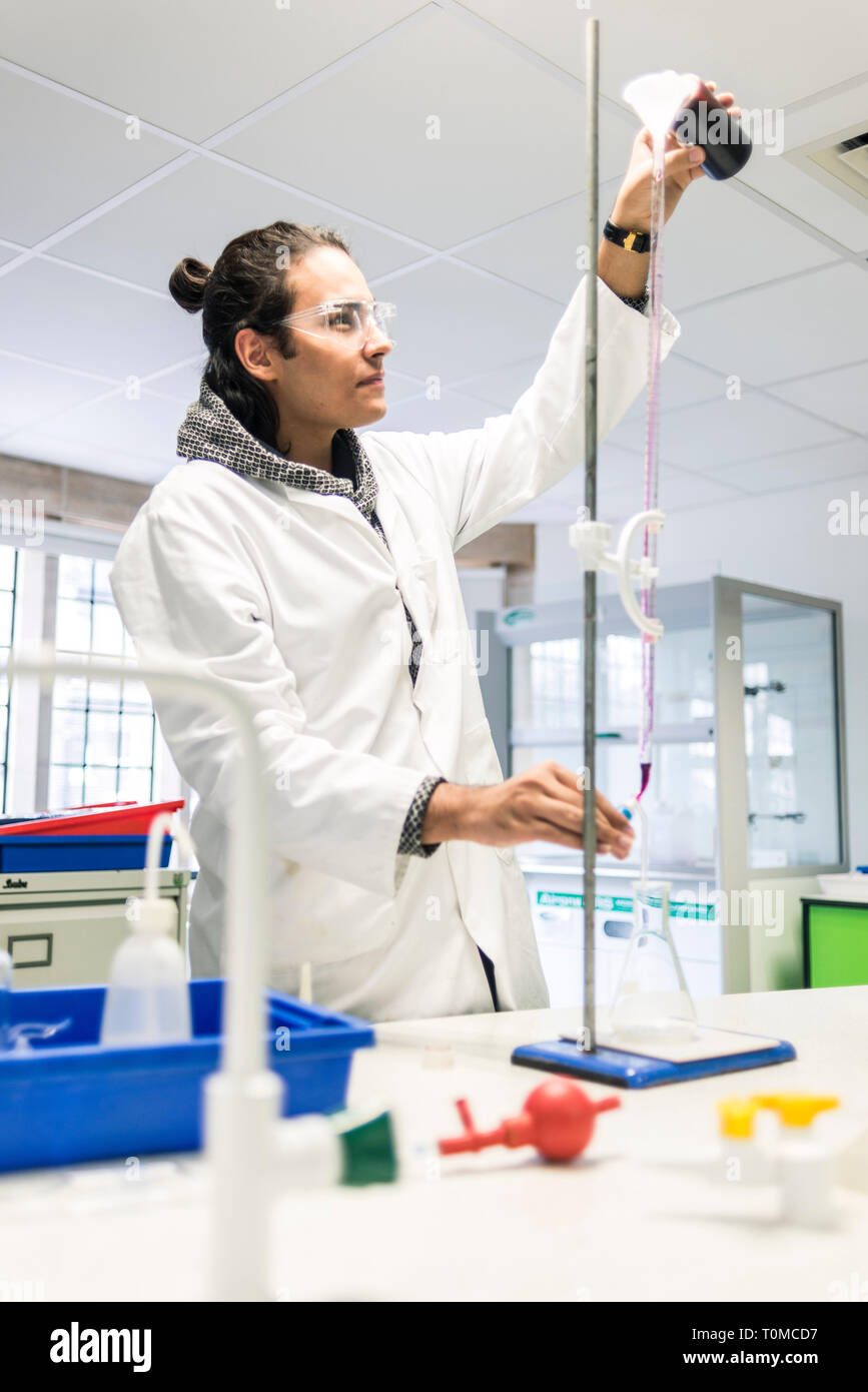 A young male student works in the science lab of a cambridge college in ...